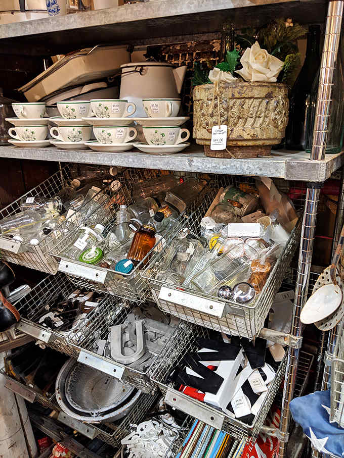 Glass bottles in wire baskets catch the light, their varied shapes and amber hues telling stories of old pharmacies, soda fountains, and household remedies.