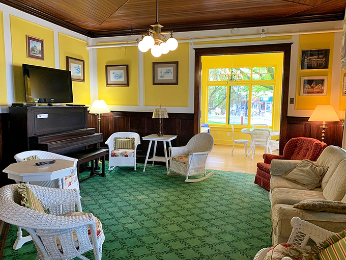 Sunshine pours through windows into this common area, where comfy seating and a television offer modern comforts in vintage surroundings.