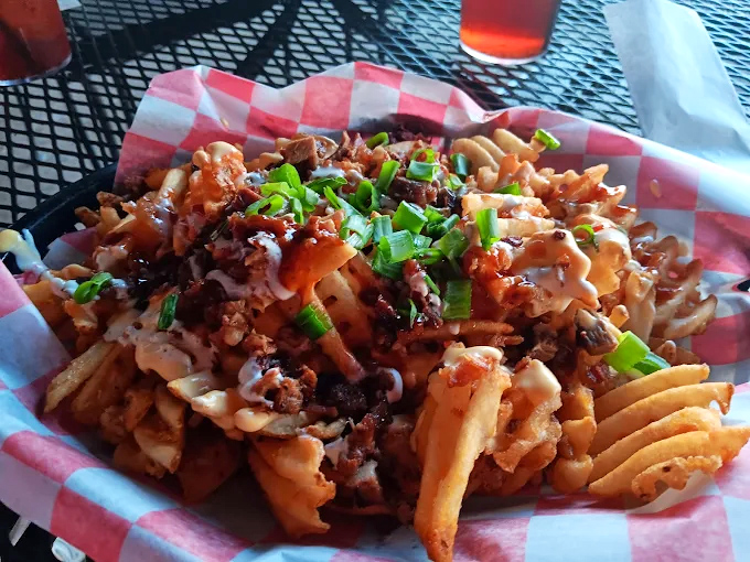 Kimchi fries &ndash; where East meets West in a glorious fusion of crispy potatoes, tangy kimchi, and smoky pulled pork.