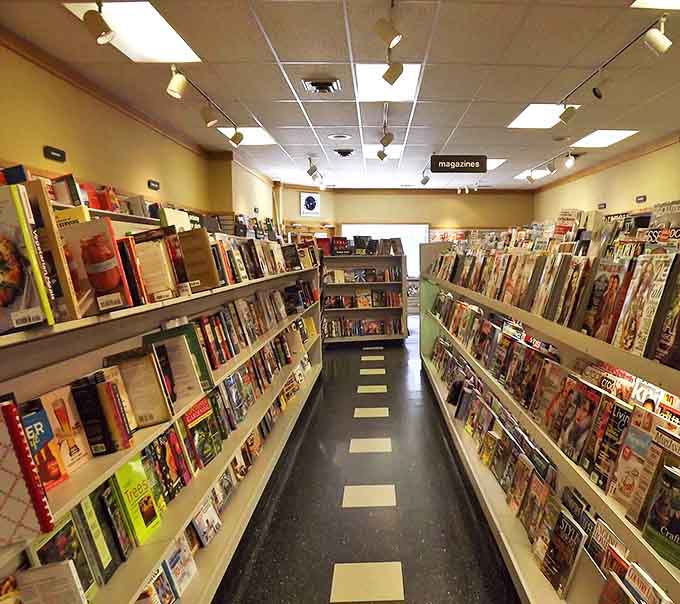 Magazines line the path like literary billboards, their covers competing for attention with splashy headlines and eye-catching photography.