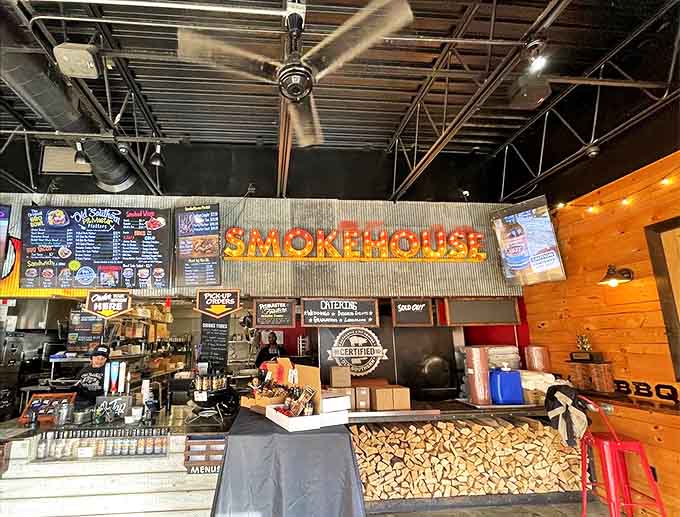 The smokehouse counter &ndash; where barbecue dreams come true beneath the warm glow of "SMOKEHOUSE" in lights.