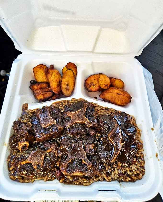 Oxtails so tender they surrender to your fork, swimming in a rich gravy alongside golden plantains &ndash; comfort food that speaks to the soul.