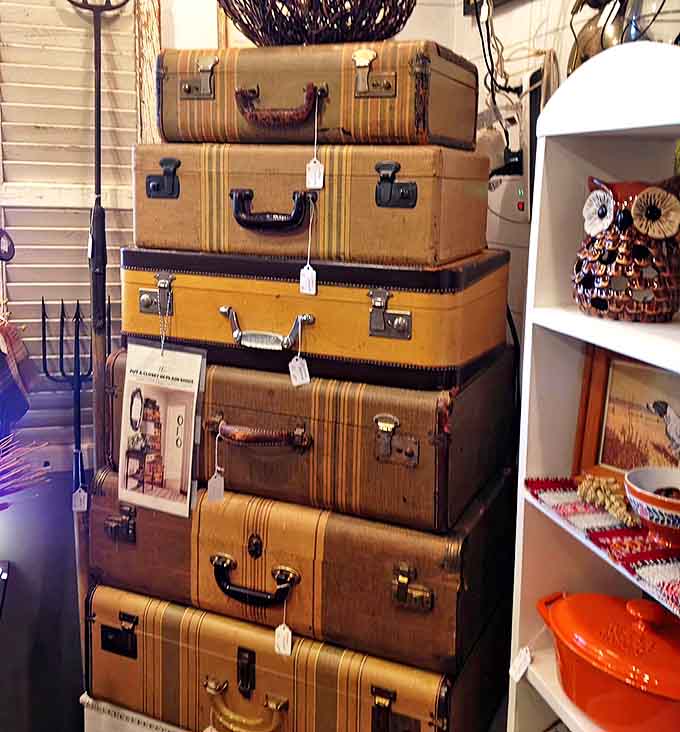 These well-traveled vintage suitcases stack like a monument to adventures past, each scratch and sticker telling tales of journeys taken decades ago.