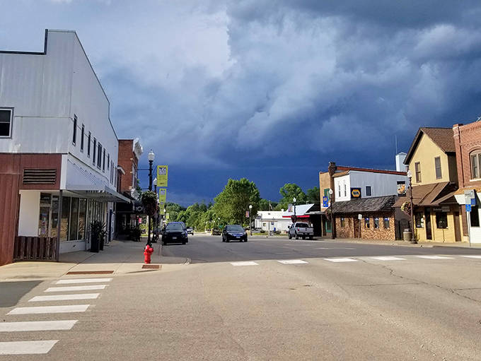 Zumbrota's main street under dramatic Minnesota skies&mdash;where weather watching qualifies as entertainment and storm clouds gather like audience members.