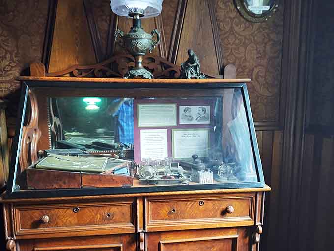 Personal artifacts in this display case offer intimate glimpses into the lives of those who once called this extraordinary structure home.