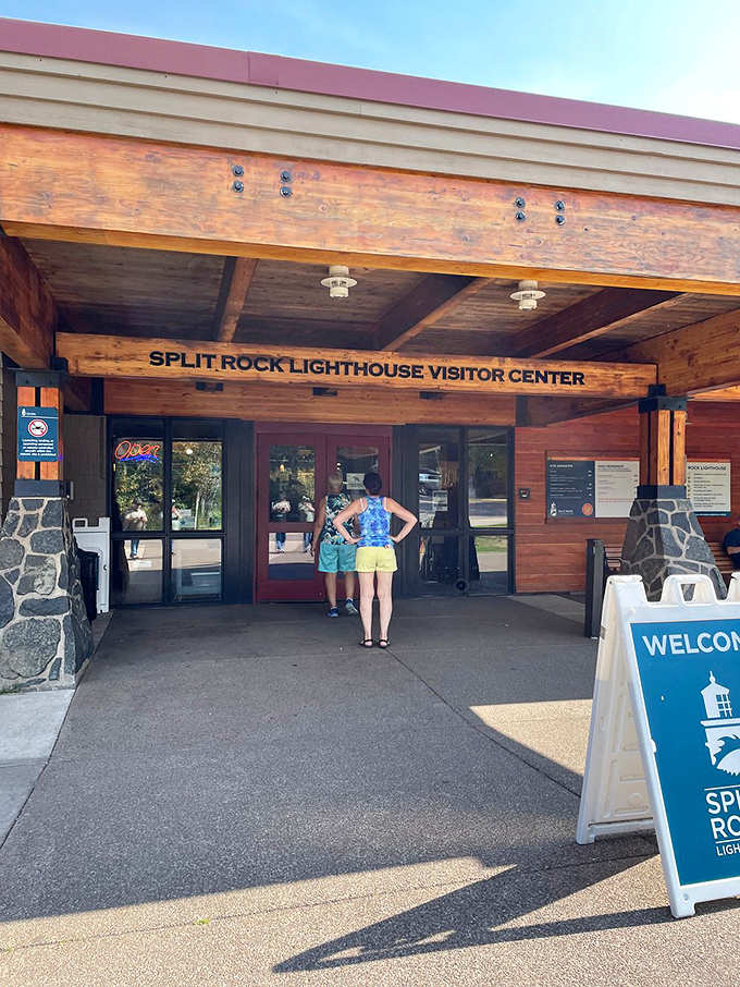 Visitors approach the welcoming entrance of Split Rock's visitor center. The rustic timber construction perfectly complements the natural surroundings of this historic site.