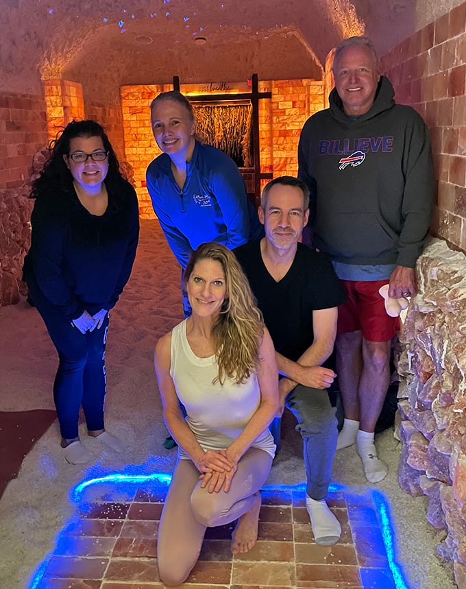 Happy visitors gather in the salt cave, proving that sometimes the best therapy happens in rooms made entirely of minerals.