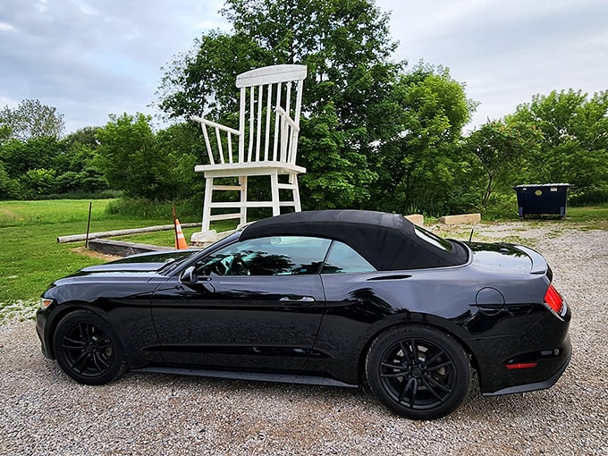 Sleek sports cars meet oversized Americana &ndash; a perfect visual metaphor for the contrast between modern speed and roadside attractions that make us pause.