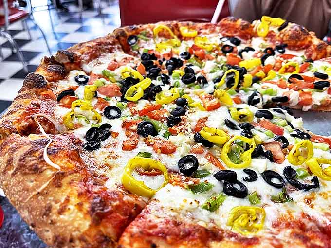 A Greek pizza that proves vegetables can party too &ndash; with black olives and peppers dancing across a canvas of melted cheese.