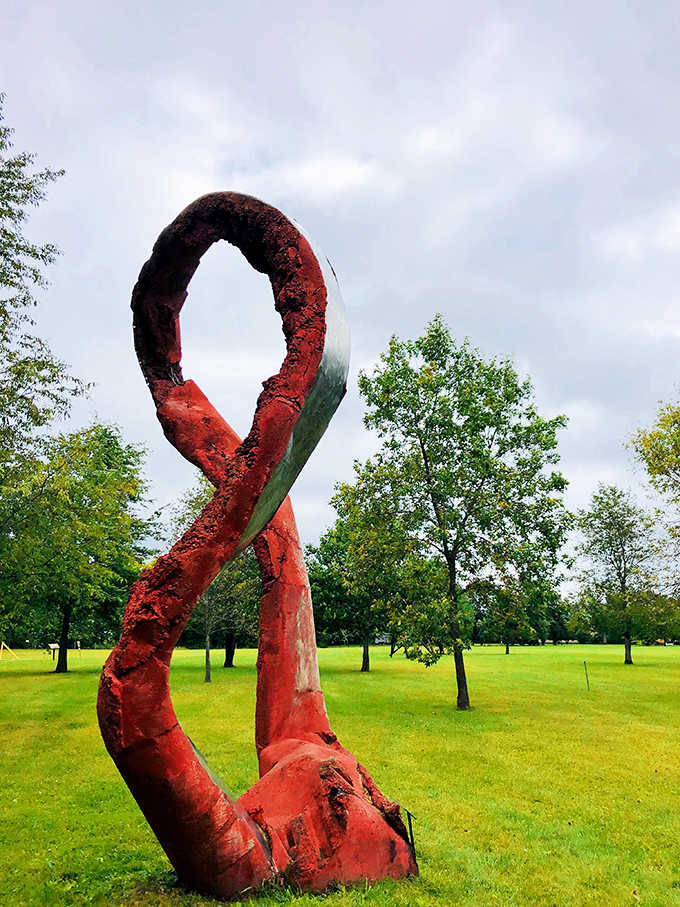 Bold red geometric forms create a striking contrast against Minnesota's blue sky, demonstrating how color can transform perception of shape and space.