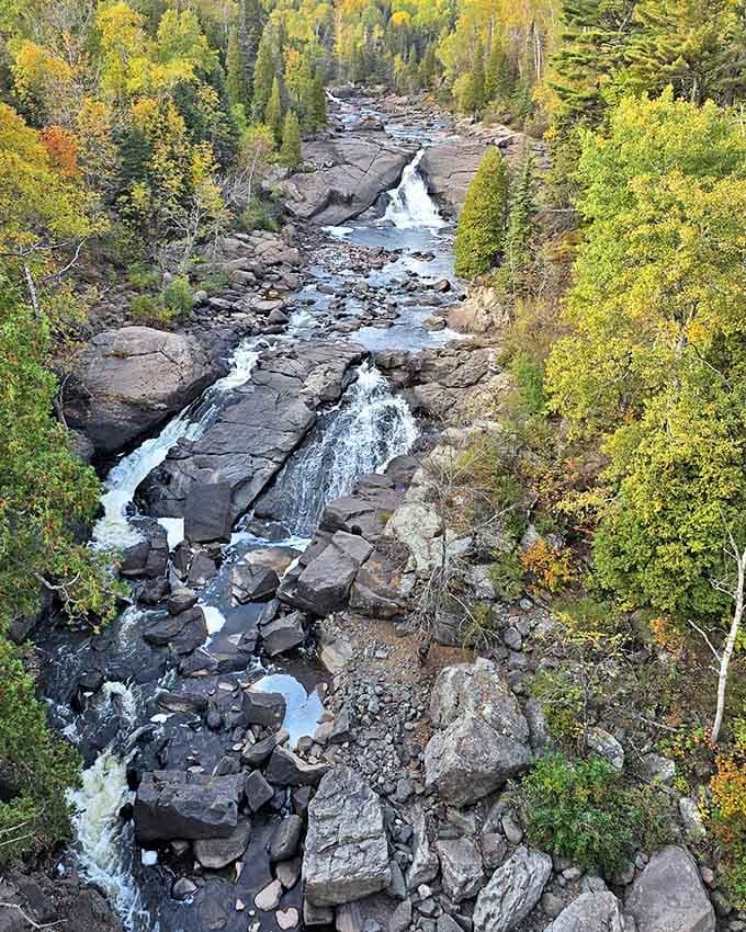 The river carves its determined path through ancient rock, a reminder that persistence can overcome even the hardest obstacles.