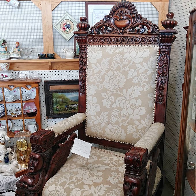 This regal throne-like chair upholstered in damask fabric sits waiting for someone with a living room worthy of its majestic presence.