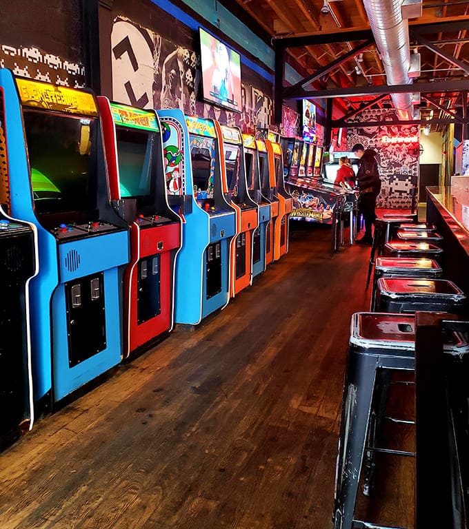 A rainbow corridor of gaming history &ndash; these vibrant cabinets stand like sentinels, each holding memories of quarters past and challenges to come.