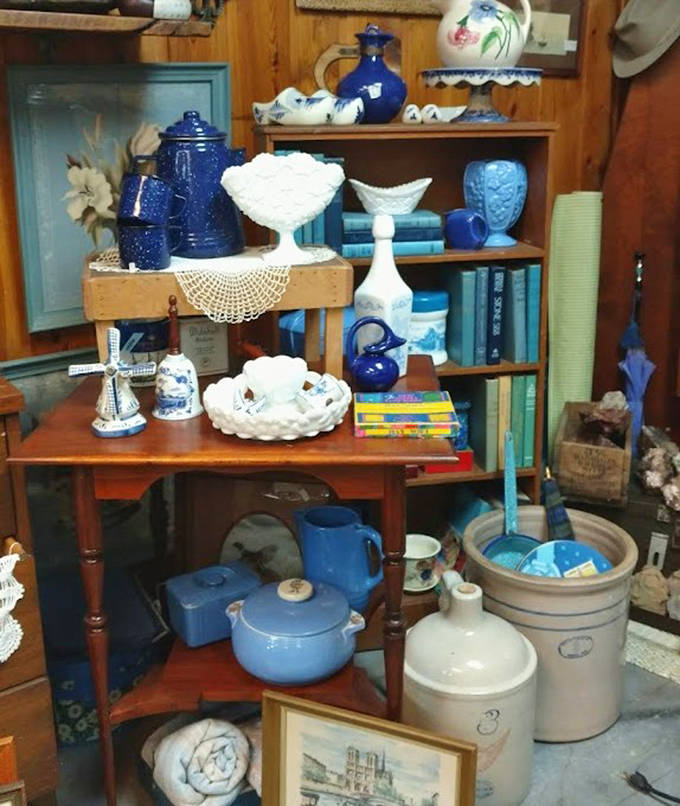 A symphony in blue and white &ndash; this carefully arranged pottery collection transforms everyday kitchen items into an artistic display worthy of a country home magazine spread.