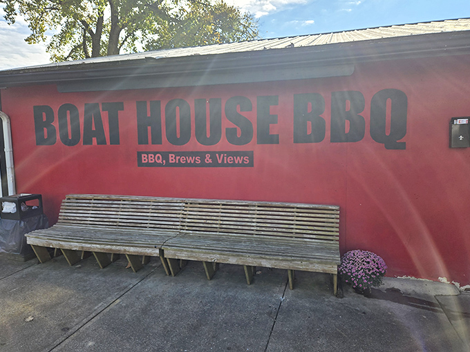 Boat House BBQ's vibrant red exterior promises smoky delights inside, where the aroma of slow-cooked meats mingles with river breezes.