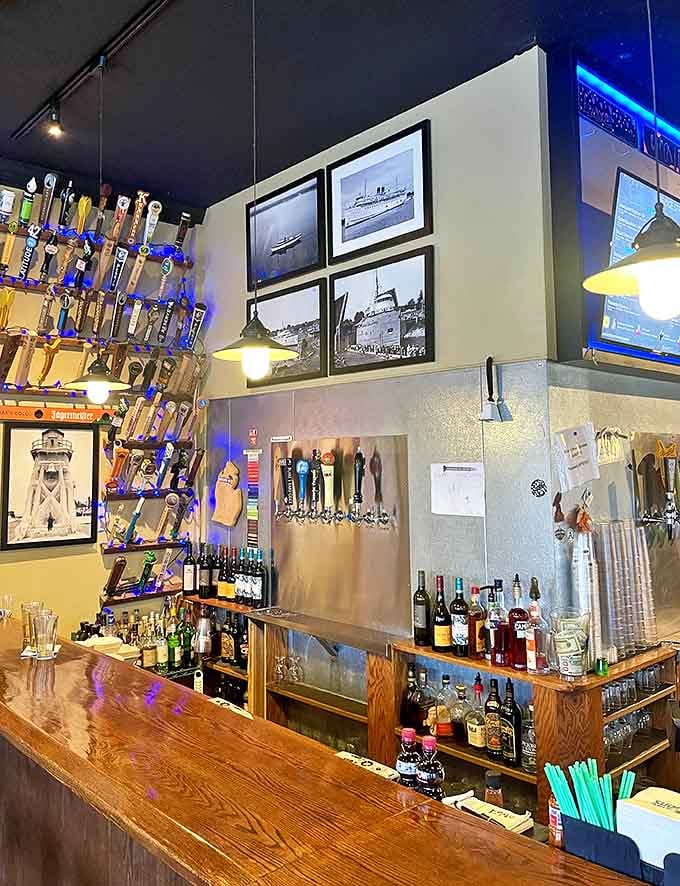 The bar area showcases Michigan's brewing prowess with dozens of taps standing at attention, while historic photos remind visitors they're part of Charlevoix's continuing story.