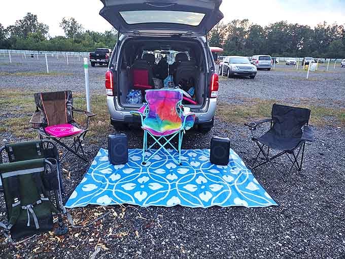 Visitors create personalized viewing setups with colorful blankets, portable speakers, and comfortable chairs &ndash; each car becomes its own private theater.