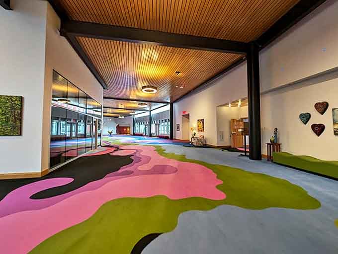 Psychedelic floors lead the way through this modern corridor, proving that even fantasy worlds need a splash of contemporary design.