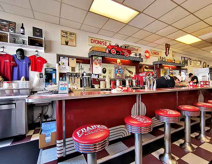 The counter seats offer front-row views to the culinary magic, where generations of cooks have perfected the art of the perfect burger.