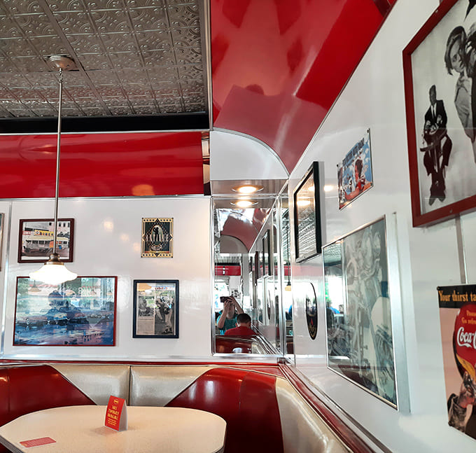Enjoy the classic diner vibes at Denny's, where nostalgic wall art and cozy red booths await you.