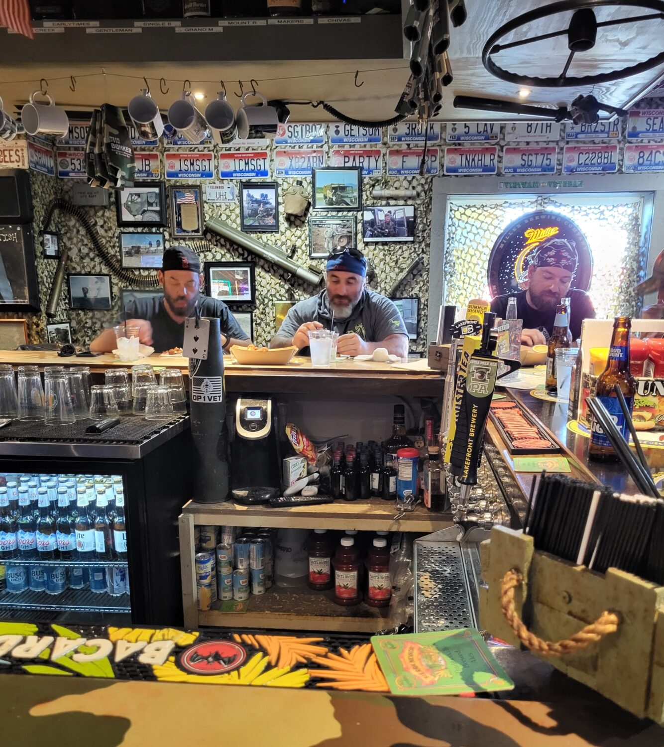 The cozy bar area showcases military memorabilia from floor to ceiling &ndash; where every mug and license plate tells a story of service.