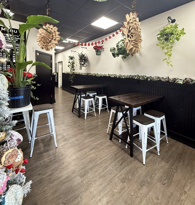 The dining area blends minimalist charm with hanging plants, creating a space where lingering over coffee feels like the right thing to do.