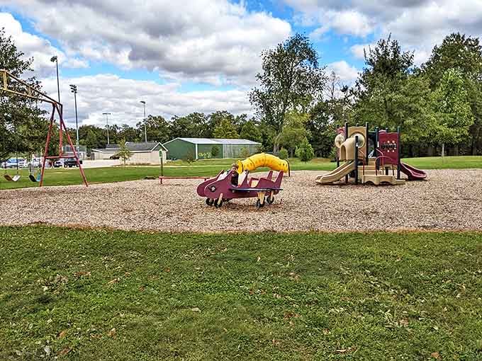 Effingham City Park: Colorful playground equipment invites energetic exploration while parents appreciate the strategically placed shaded benches nearby.