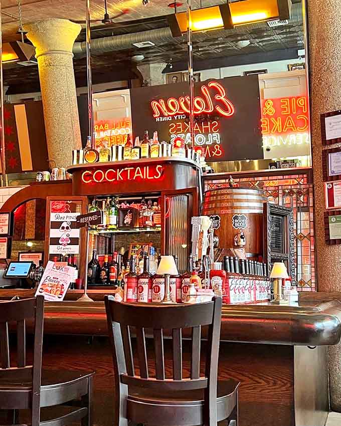 The bar area glows with promise &ndash; neon signs and bottles standing at attention, ready to transform your meal into a celebration.