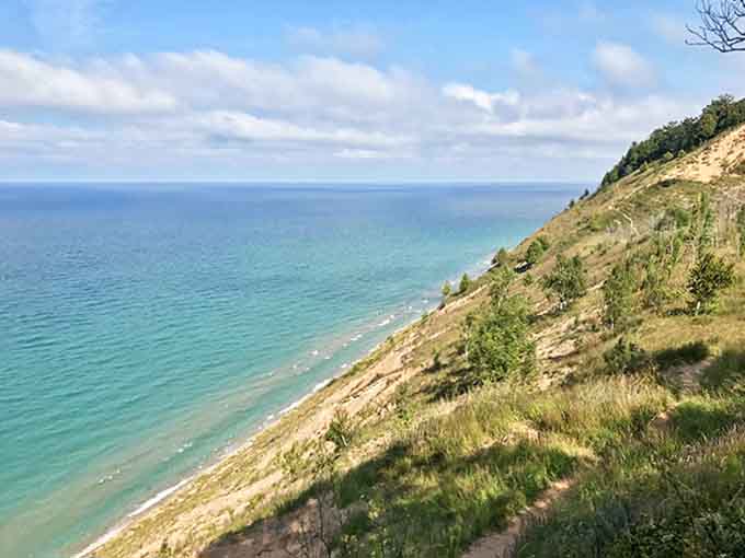 The reward for your climb &ndash; breathtaking coastal views where emerald waters meet golden shores beneath an endless sky.