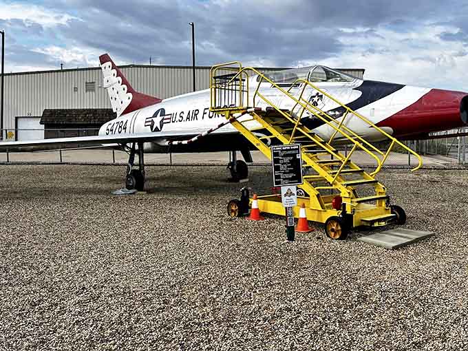 The F-100C Super Sabre, affectionately nicknamed "The Hun," waits for phantom pilots who once pushed it to supersonic speeds.