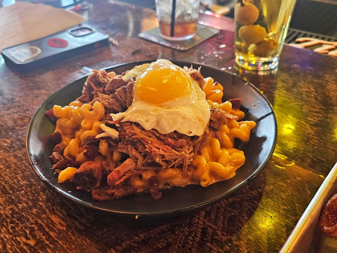 Mac and cheese topped with a sunny-side-up egg and pulled meat &ndash; comfort food elevated to art form status.