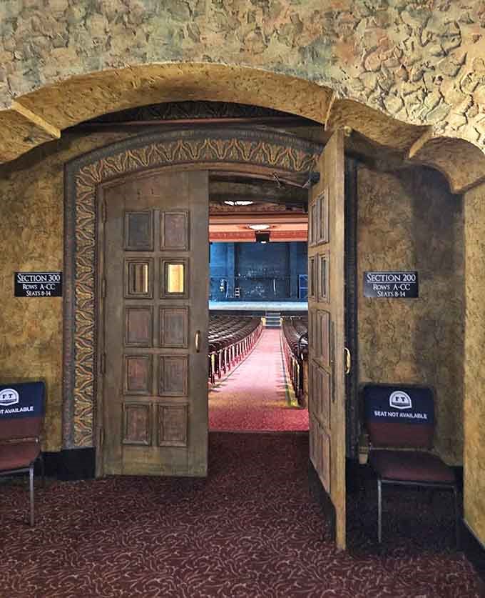 Arched doorways beckon patrons into the theater's inner sanctum, where everyday concerns dissolve and the anticipation of performance takes over.