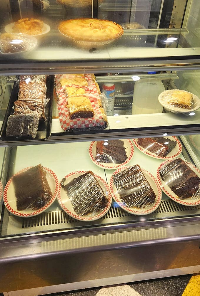Display case filled with homemade pies and cakes &ndash; edible art that makes choosing just one slice a delicious dilemma.