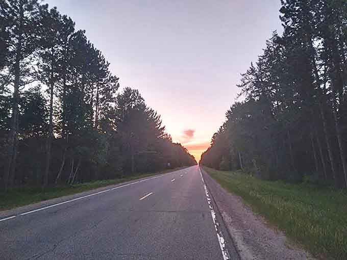 The byway takes on a dreamlike quality as sunset paints the sky, turning an ordinary drive into a memory that lingers.