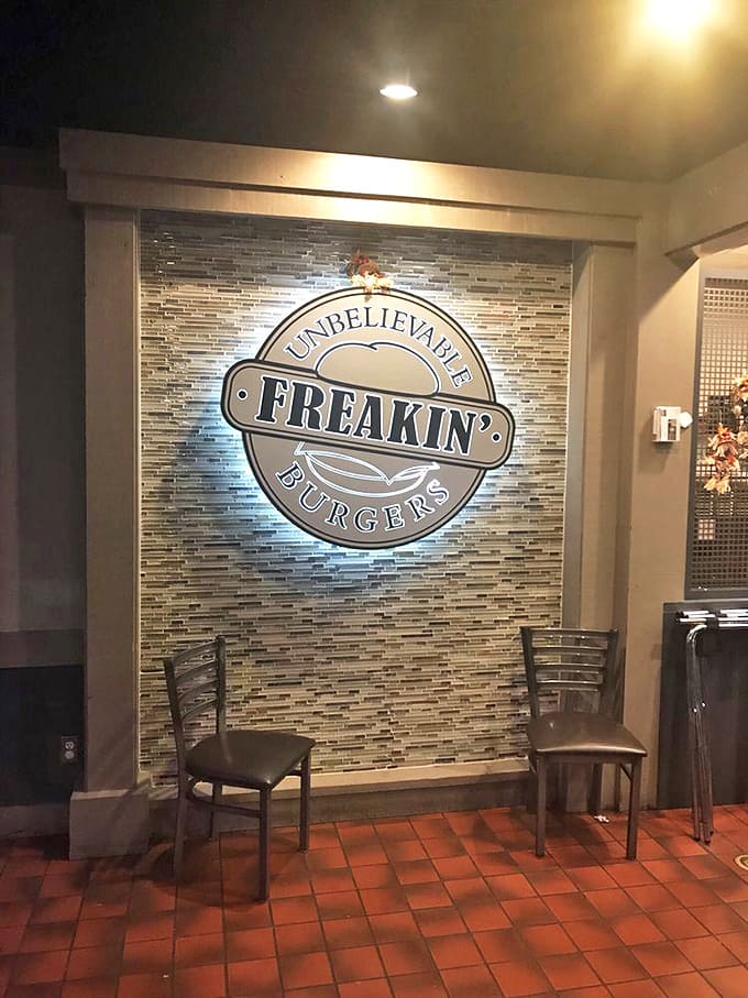 The illuminated logo serves as both decoration and solemn promise of what awaits your taste buds. A burger beacon in the night.