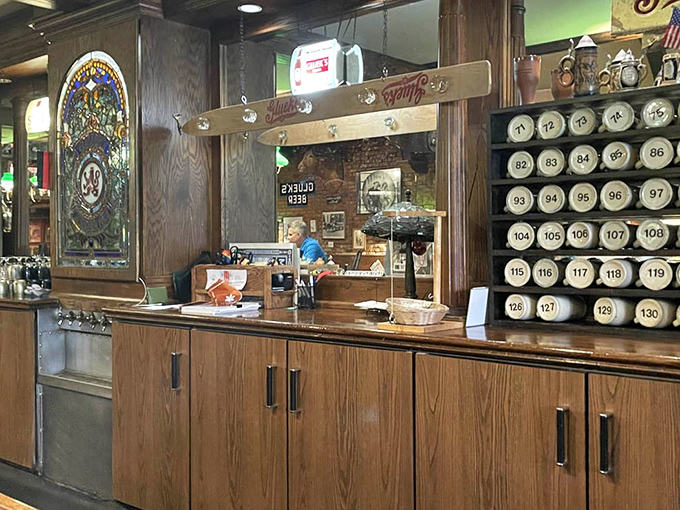 Bar area (other angle): The numbered beer steins lining the wall tell stories of regulars who've claimed their spot in Gluek's living history.