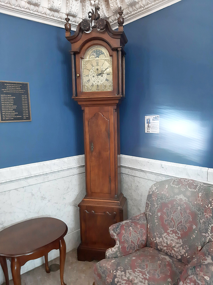 The stately grandfather clock stands sentinel in the reading room, its polished wood case and ornate face marking the hours as generations of readers have come and gone.