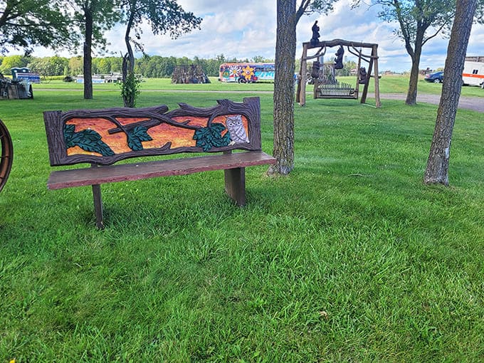 Carved benches and metal art pieces dot the landscape, creating rest stops for contemplative treasure hunters.