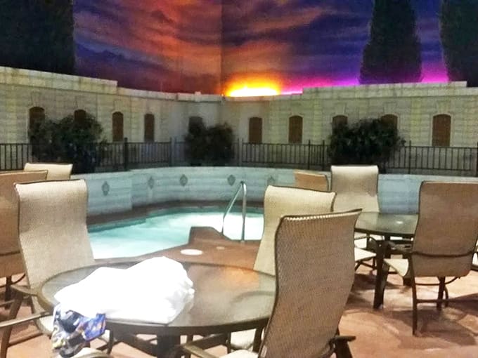 Twilight hues cast a perpetual sunset glow over this bubbling retreat where conversations simmer as warmly as the water.