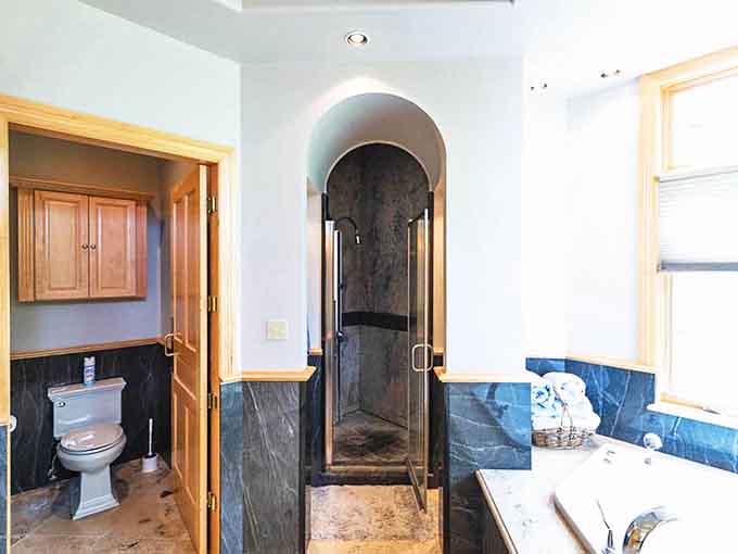 Sleek stone and glass create a spa-like shower experience, where you'll linger longer than necessary just because it feels so darn luxurious.