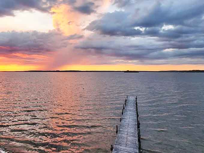 The dock stretches toward infinity at sunset, creating the perfect stage for nature's nightly masterpiece of color and light.