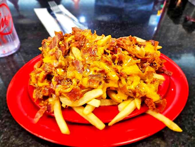 Loaded cheese fries with bacon bits prove that sometimes more is more, especially when it comes to comfort food.