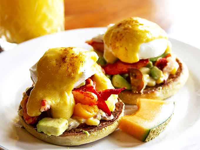 Eggs Benedict reimagined with succulent lobster and fresh vegetables &ndash; breakfast that makes you want to applaud the chef.