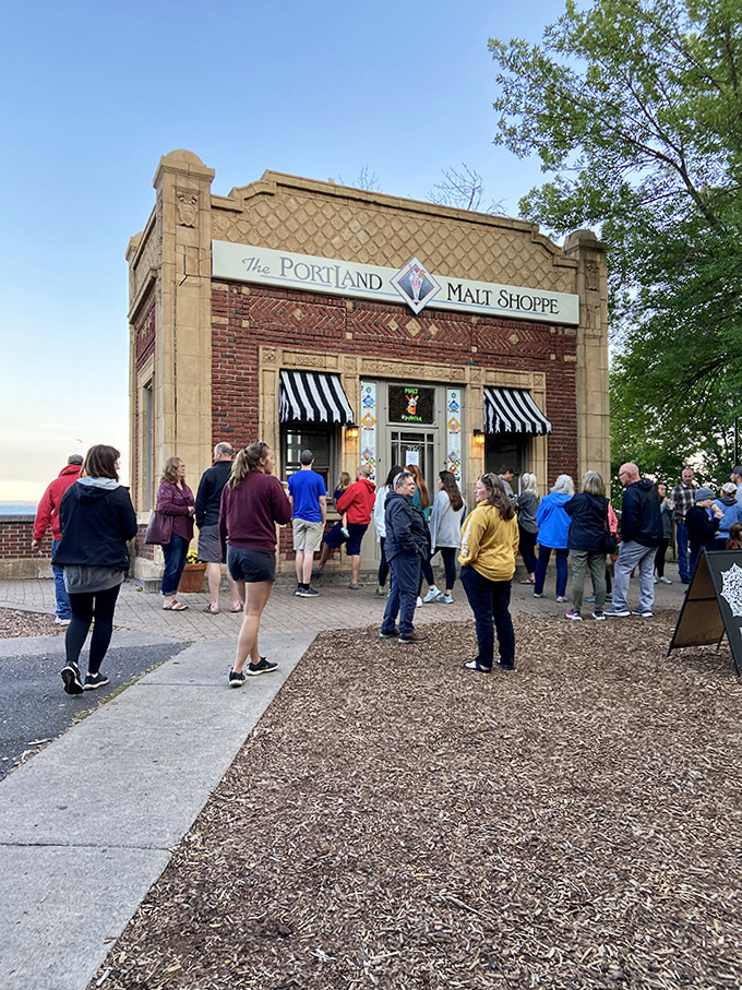 The line forms for frozen happiness. Like a pilgrimage to the dairy promised land, these devotees know that patience yields the sweetest rewards.
