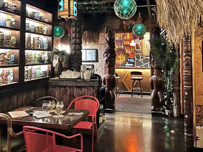 Intimate dining spaces feature bamboo walls, thatched details, and colorful lighting that creates the perfect atmosphere for tropical escapism.