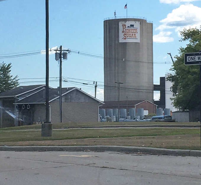 Industrial heritage meets natural beauty, as historic structures along the riverbank complement the bridge's own century-old engineering.