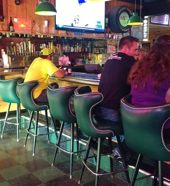 Green vinyl barstools invite solo diners and couples to perch, sip, and watch the bartenders work their magic behind the well-worn counter.