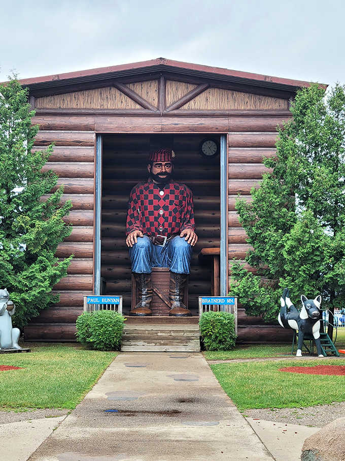 The legendary lumberjack himself sits tall in his cabin, greeting visitors by name with folksy Midwestern charm.