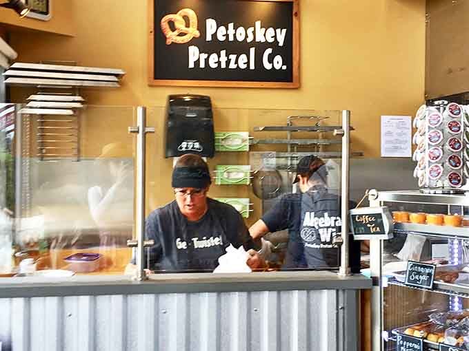 Behind the counter, pretzel artisans work their magic, transforming simple ingredients into twisted treasures with practiced hands and genuine care.
