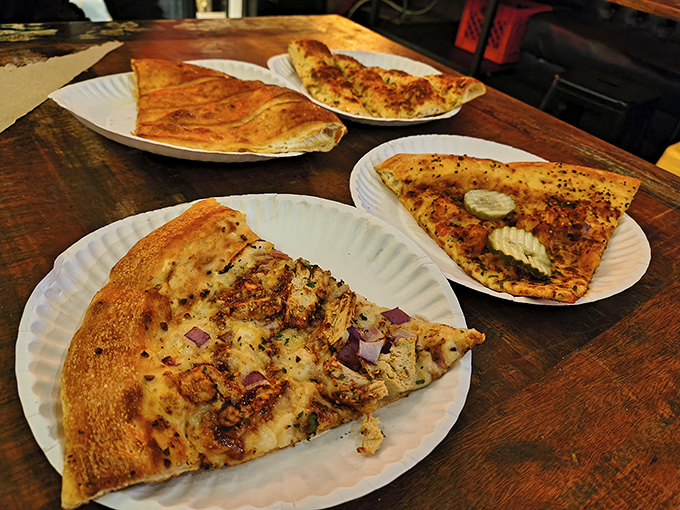 A quartet of slices showcasing Mikey's range &ndash; from classic cheese to specialty creations, each triangle of heaven demands both hands and possibly a bib.